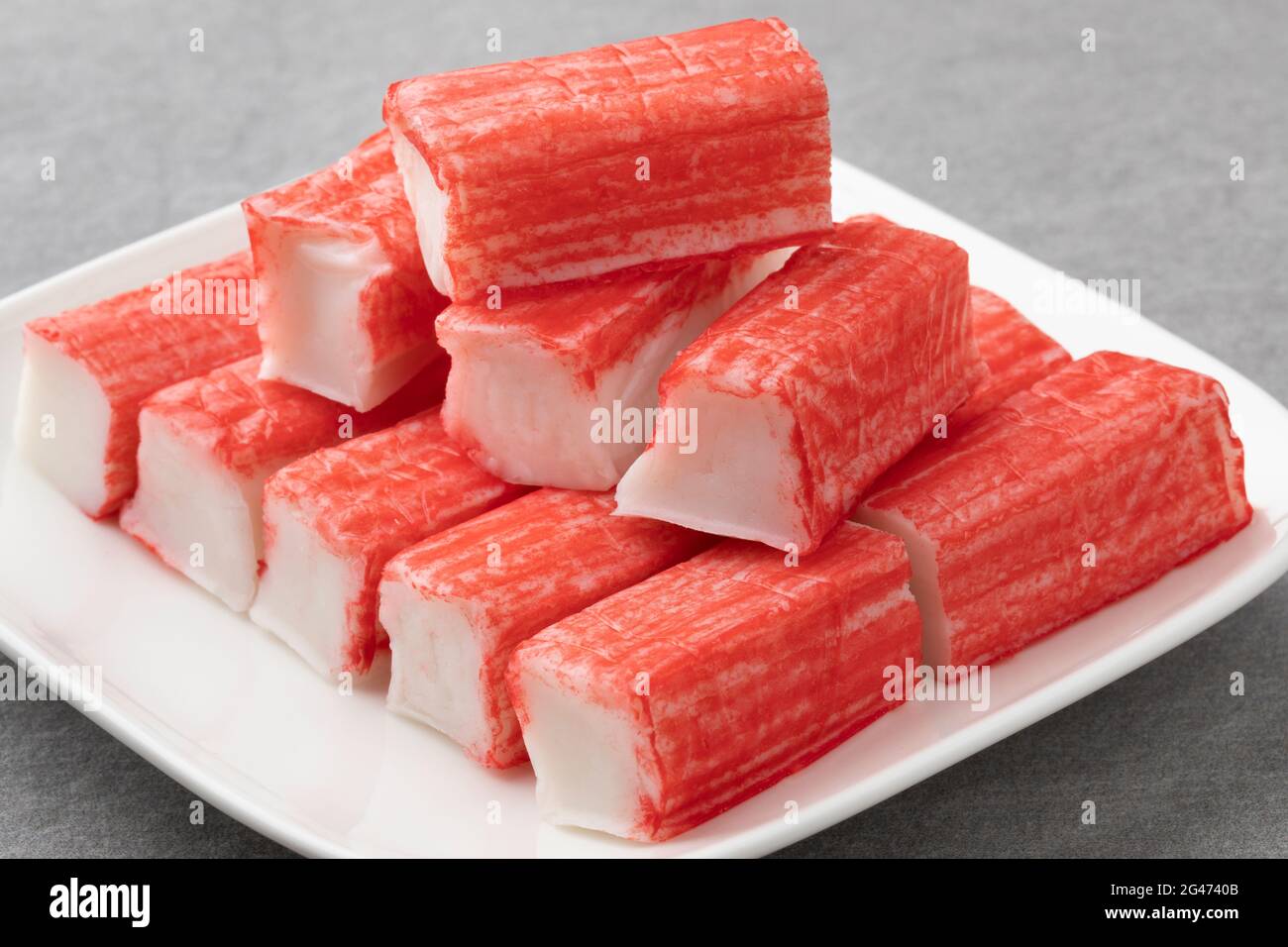 Plate with whole and half red Japanese Surimi sticks close up Stock ...