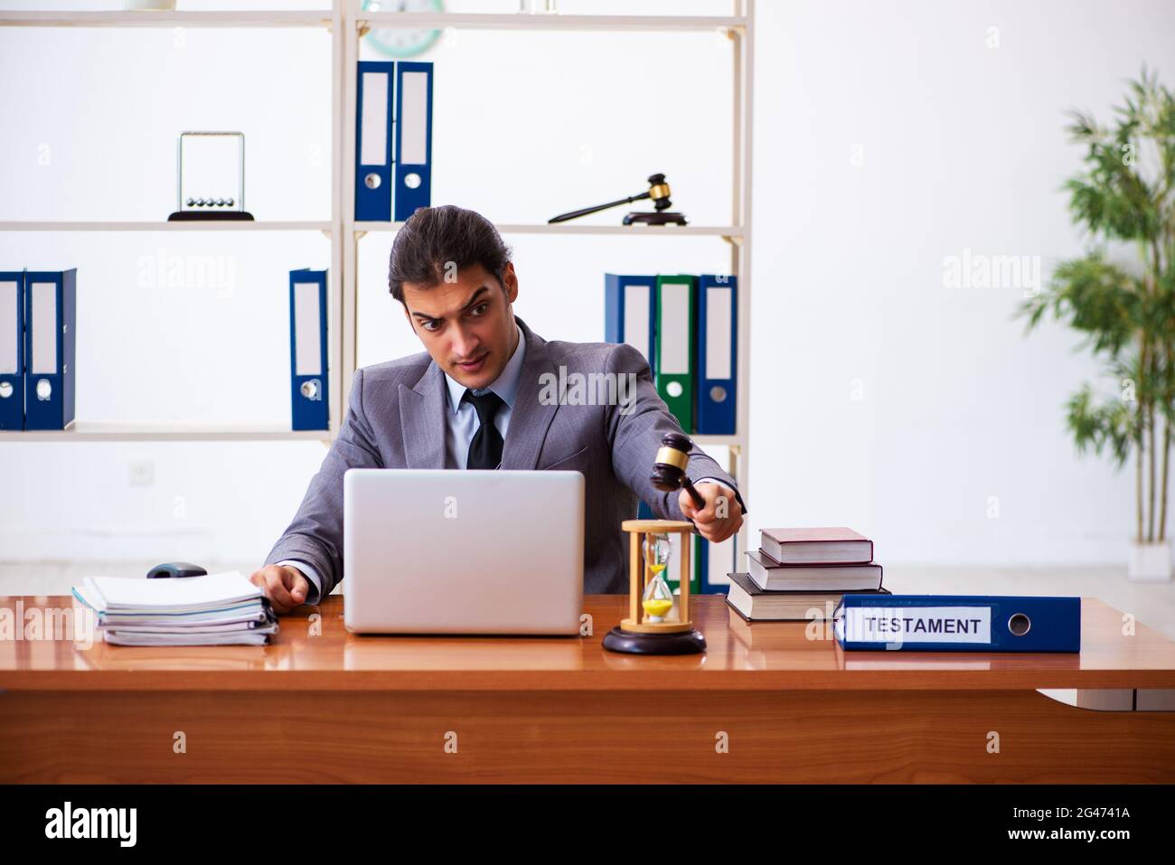 Young lawyer sitting in the office Stock Photo - Alamy