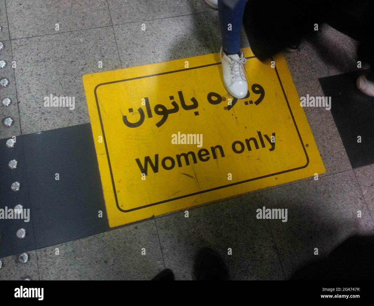 Female's foot stepping on a "Women only" sign on the ground Stock Photo ...