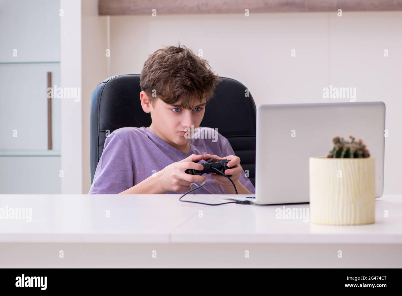 Boy playing computer games at home Stock Photo - Alamy