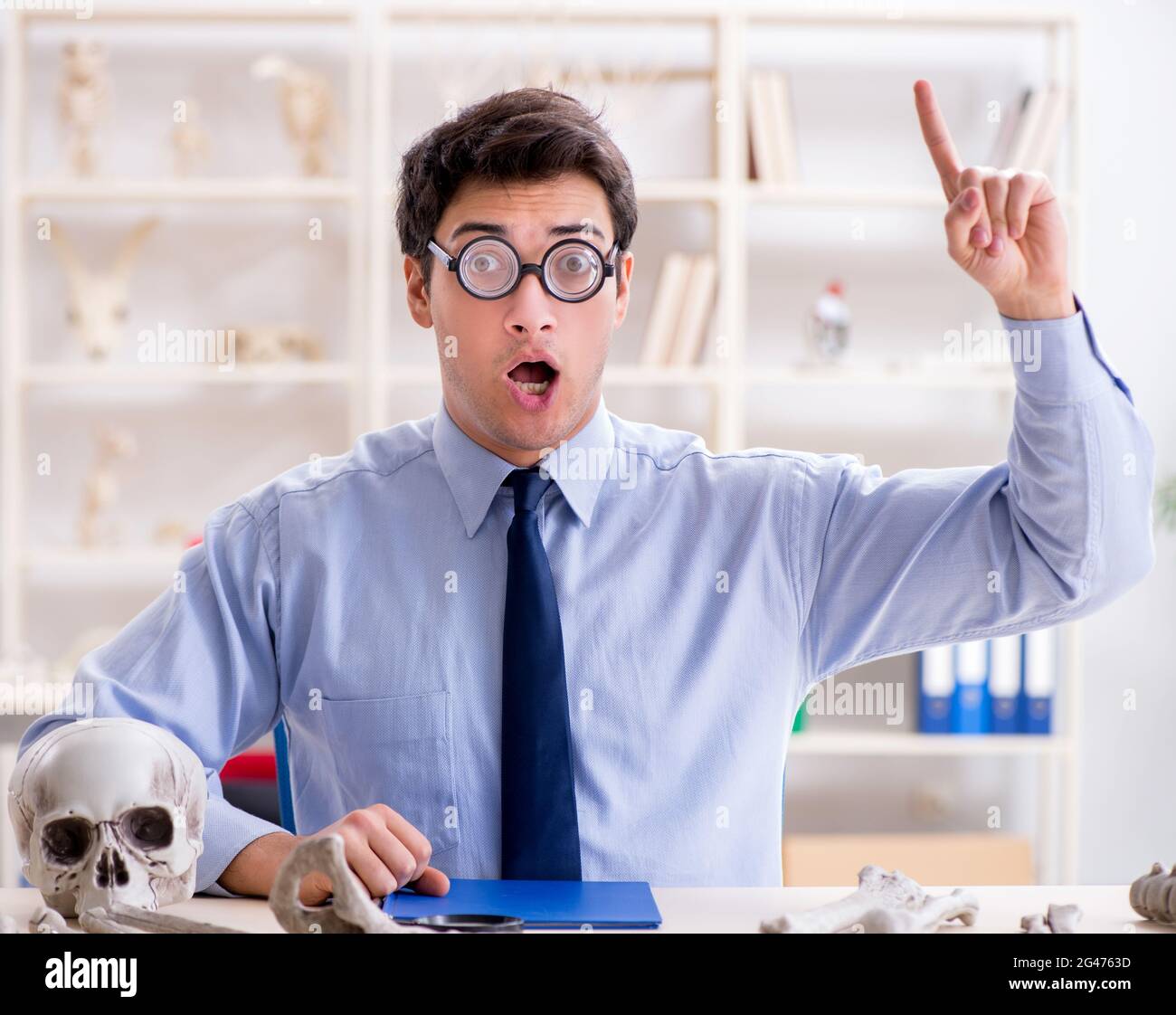 The funny crazy professor studying human skeleton Stock Photo - Alamy