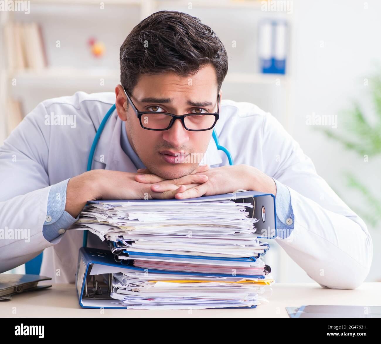 The busy doctor with too much work in hospital Stock Photo - Alamy
