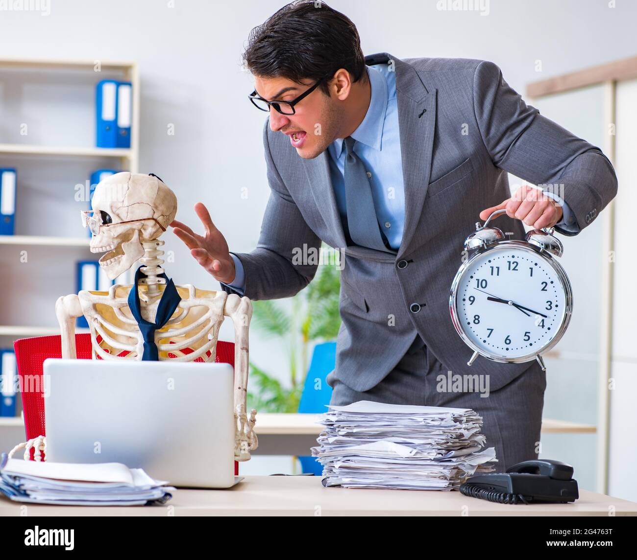 The angry boss yelling at his skeleton employee Stock Photo - Alamy