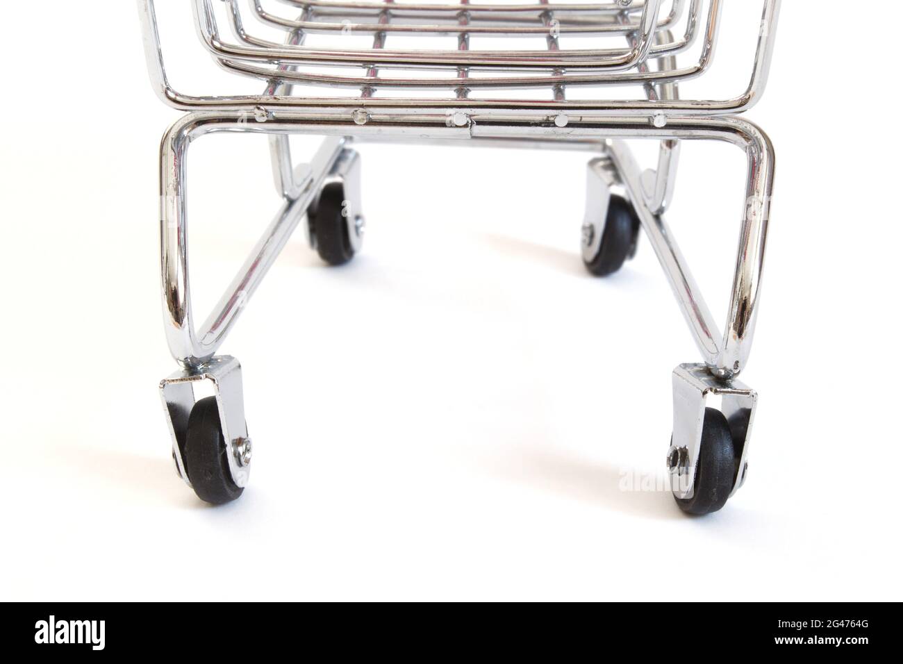 Shopping trolley or cart wheels close-up, isolated on white background ...