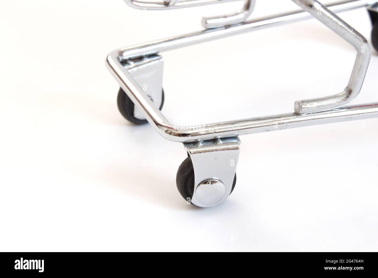 Shopping trolley or cart wheels close-up, isolated on white background ...
