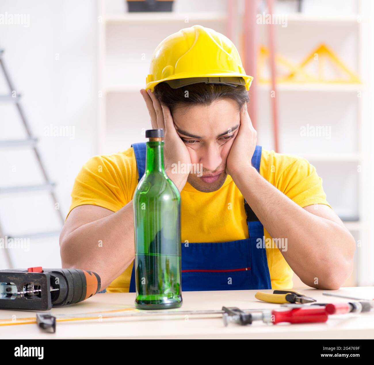 The drunk engineer working in the workshop Stock Photo - Alamy