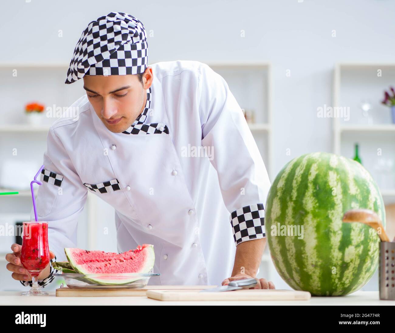 The male cook with watermelon in kitchen Stock Photo - Alamy