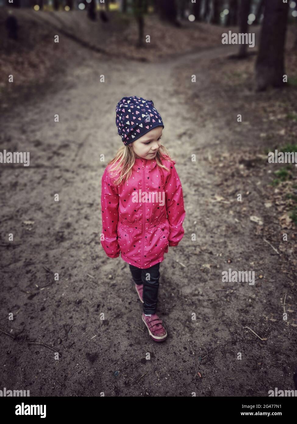 Vertical shot of the Caucasian child from the front wearing pink in the ...