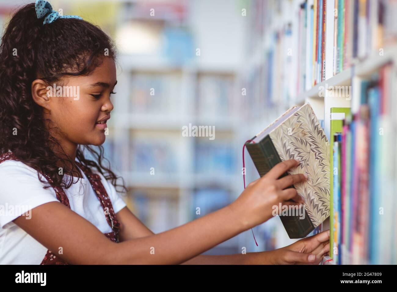 Taking book from shelf hi-res stock photography and images - Alamy