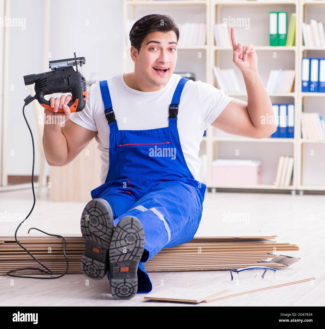 The young worker working on floor laminate tiles Stock Photo - Alamy
