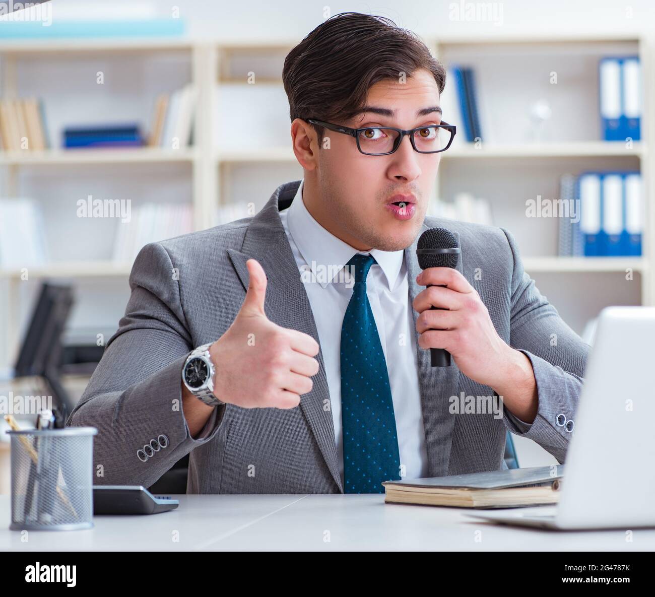The businessman singing in the office Stock Photo - Alamy
