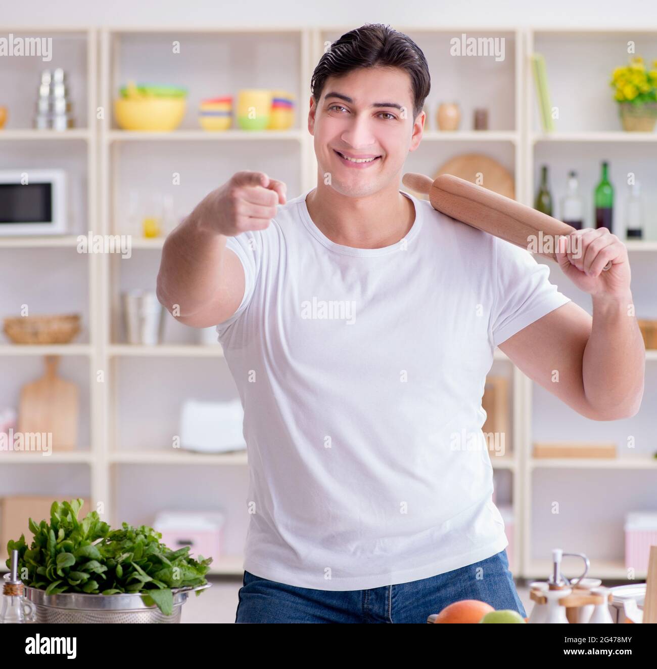 The young male cook working in the kitchen Stock Photo - Alamy