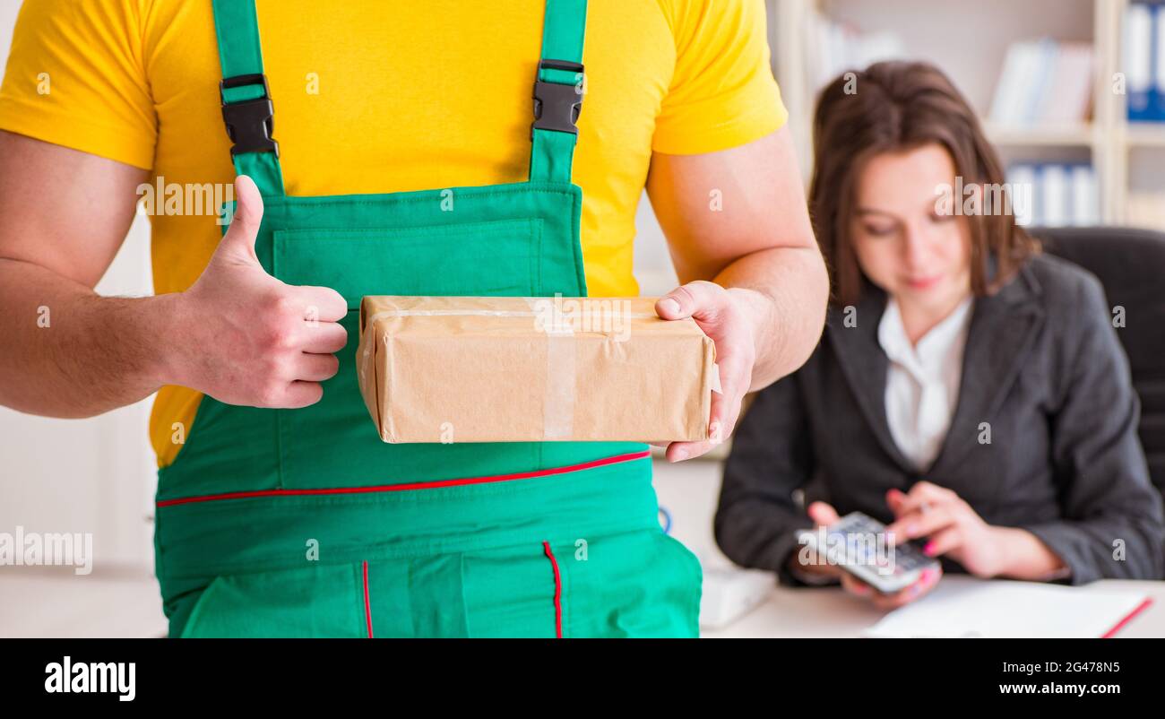 The postman delivering parcel to the office Stock Photo - Alamy
