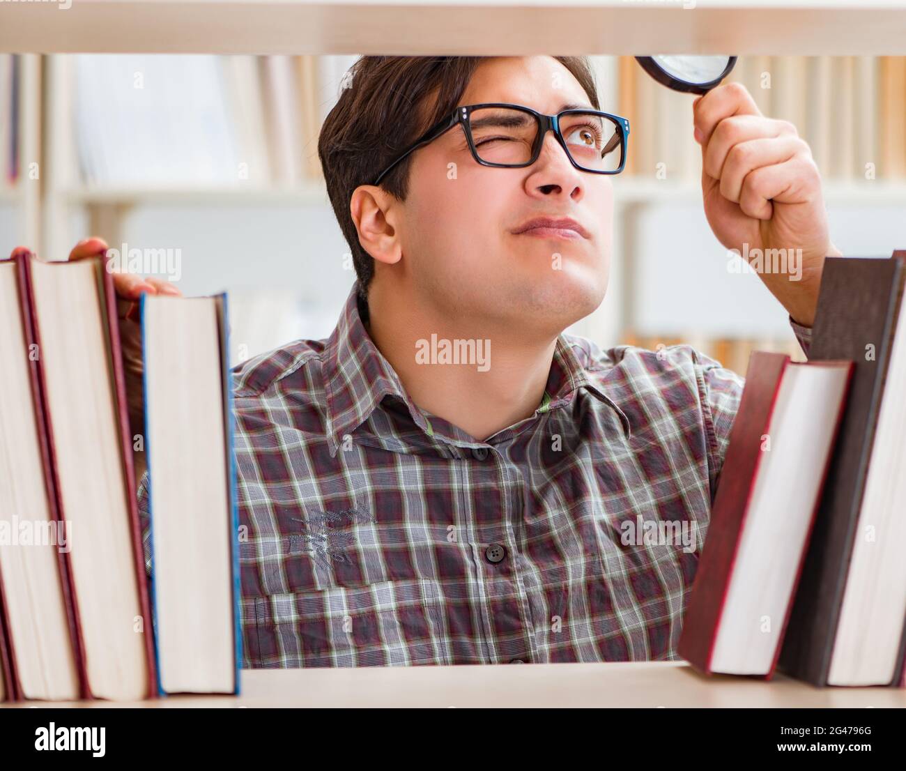 The young student looking for books in college library Stock Photo - Alamy