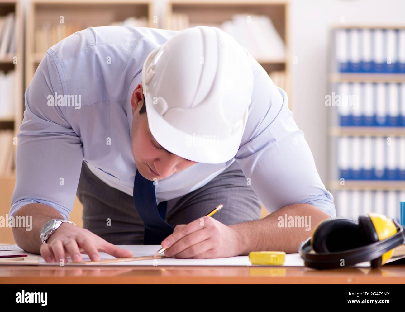 The engineer supervisor working on drawings in the office Stock Photo ...