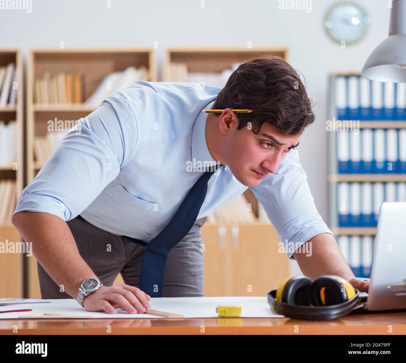 The engineer supervisor working on drawings in the office Stock Photo ...