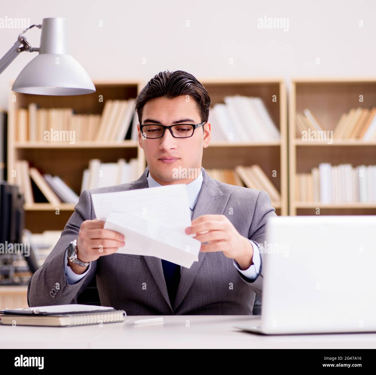 The businessman receiving letter envelope in office Stock Photo - Alamy