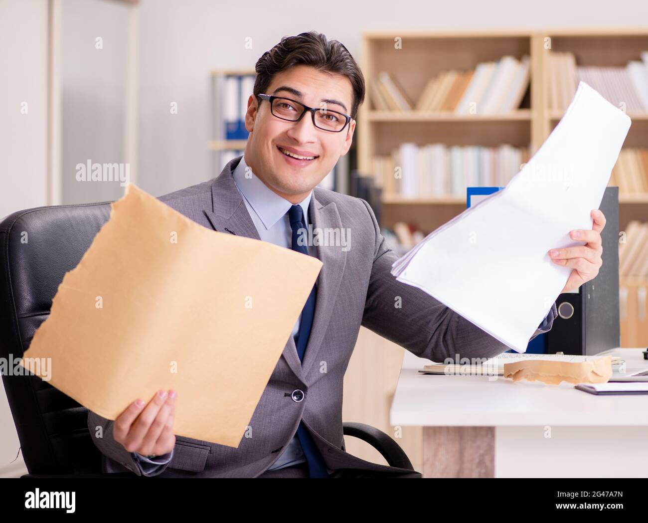 The businessman receiving letter in the office Stock Photo - Alamy