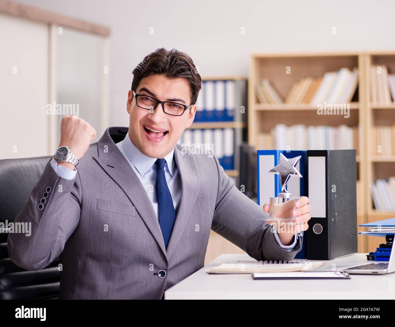 The businessman receiving award in the office Stock Photo - Alamy