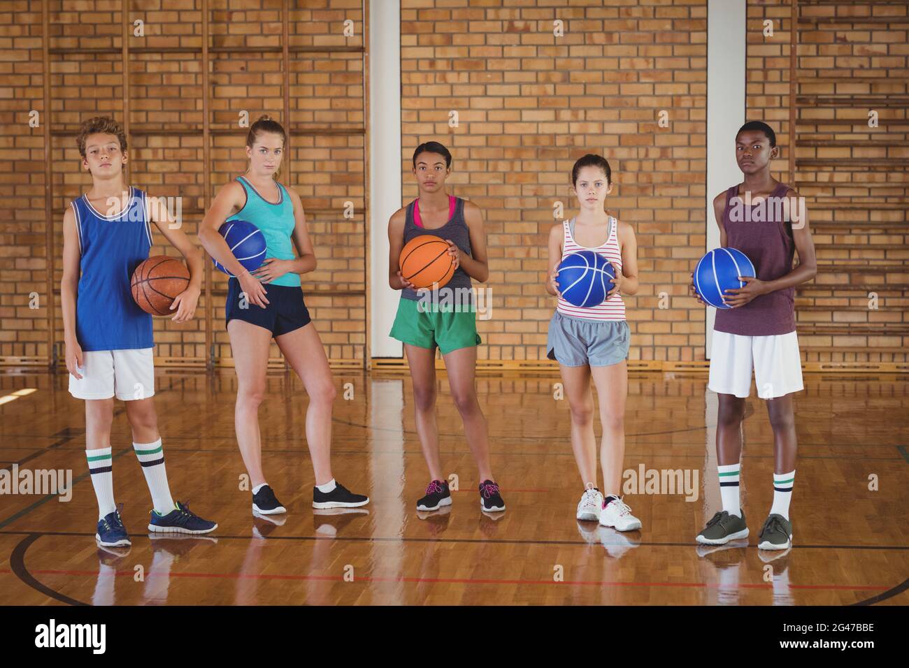 Group of high school team holding a basketball in the court Stock Photo ...