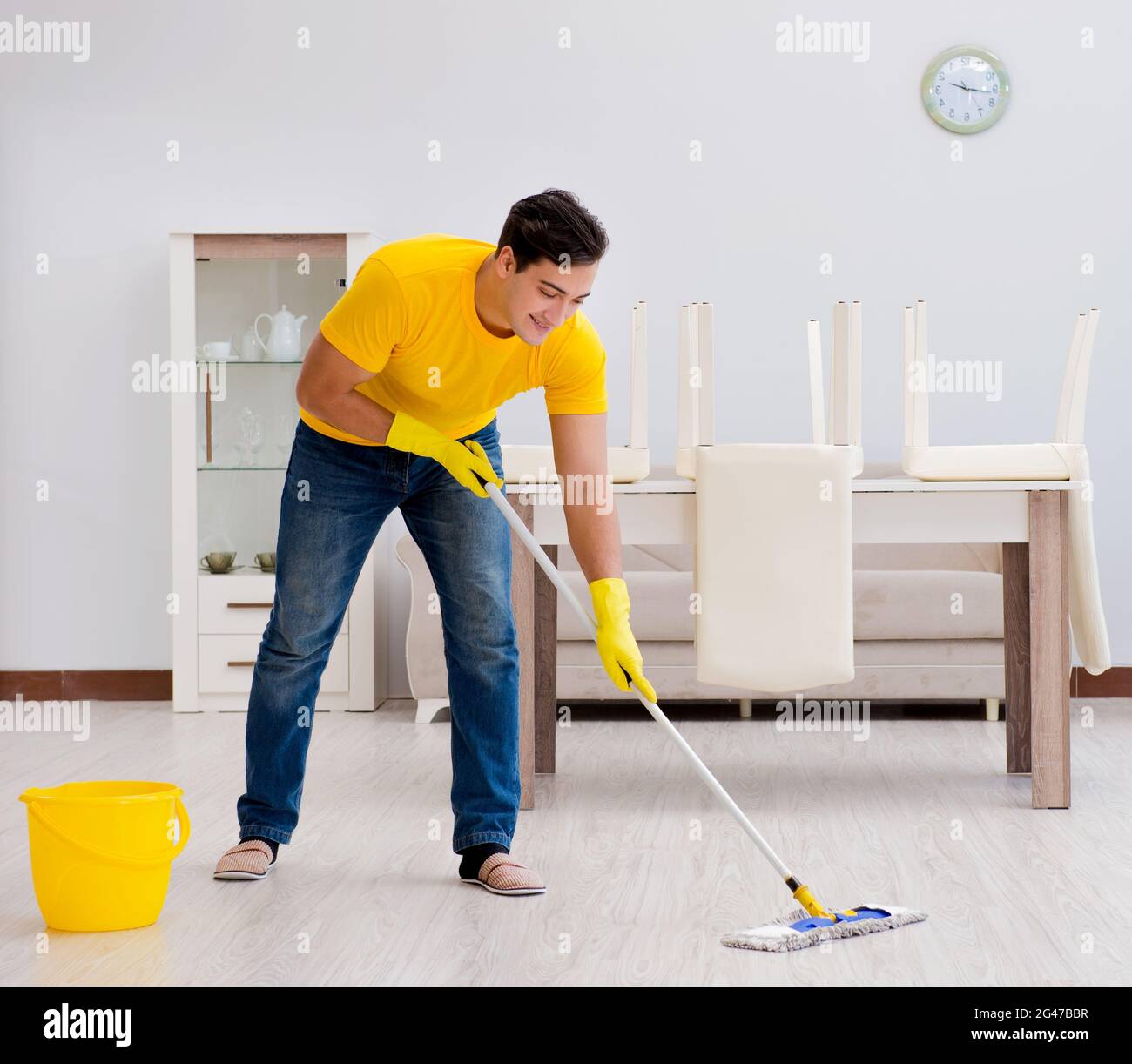 The man cleaning the house helping his wife Stock Photo - Alamy