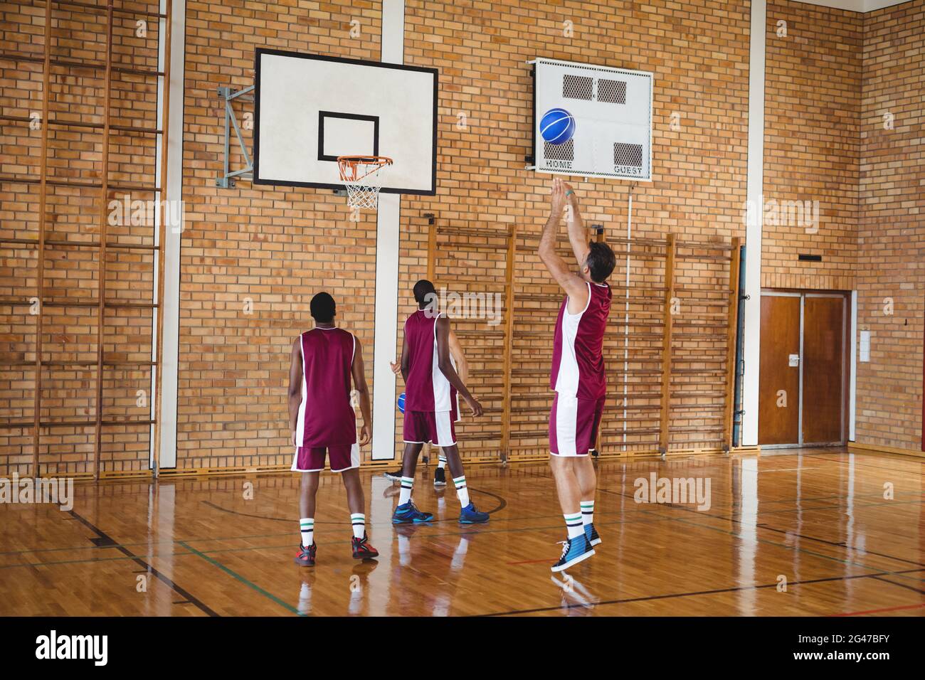 Basketball players playing in the court Stock Photo - Alamy