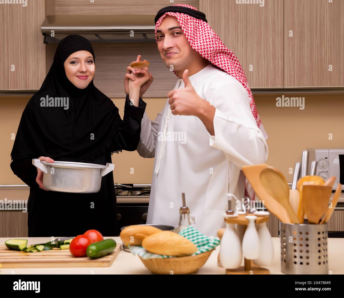 The young arab family in the kitchen Stock Photo - Alamy