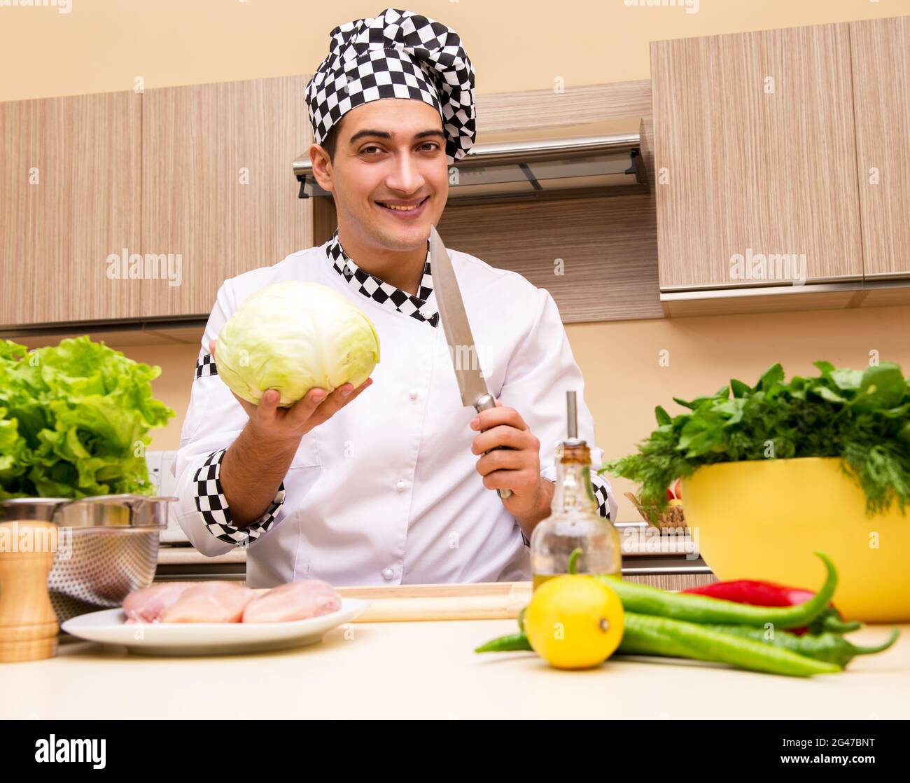 The young chef working in the kitchen Stock Photo - Alamy