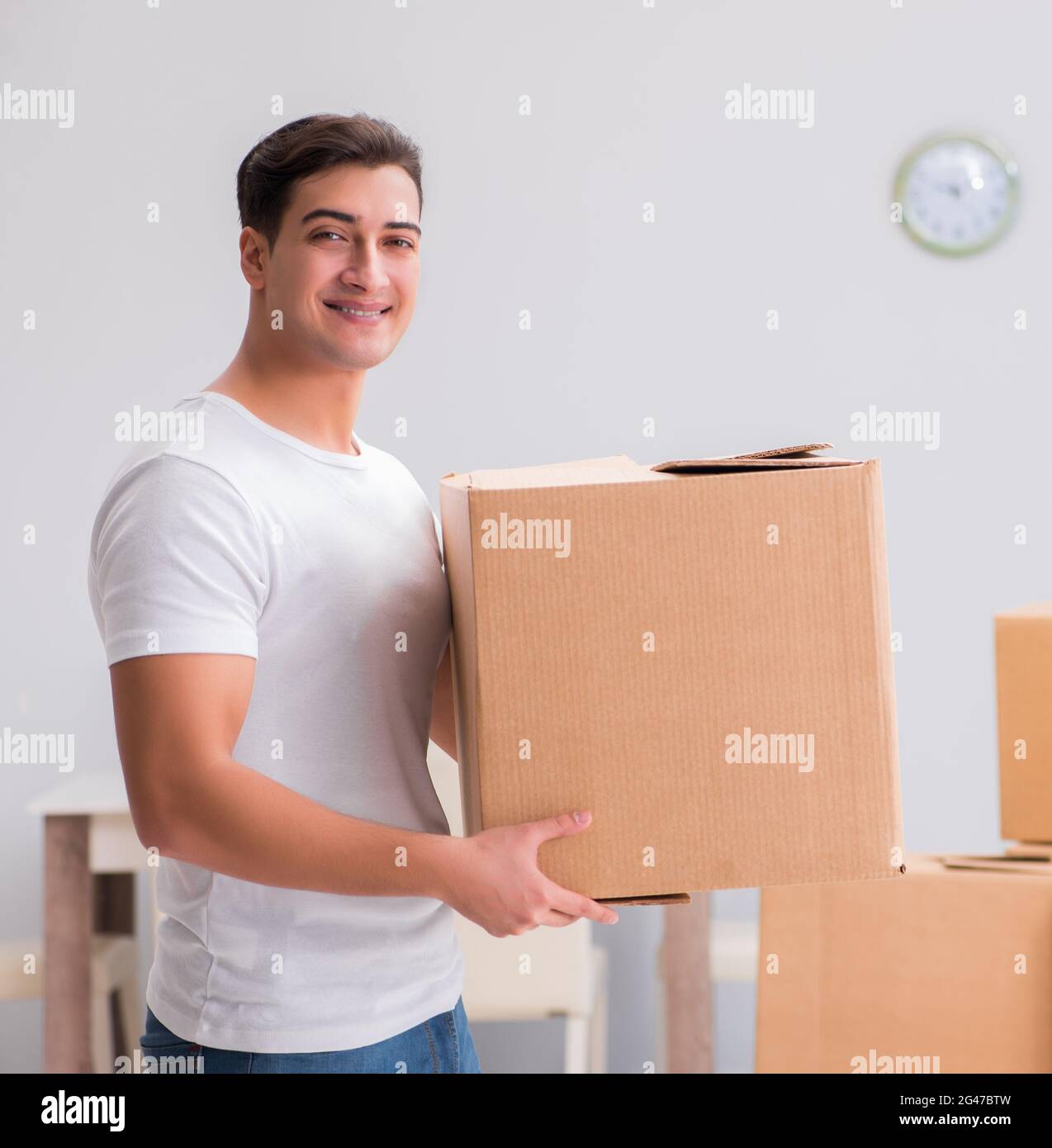 The man carrying boxes at home Stock Photo - Alamy