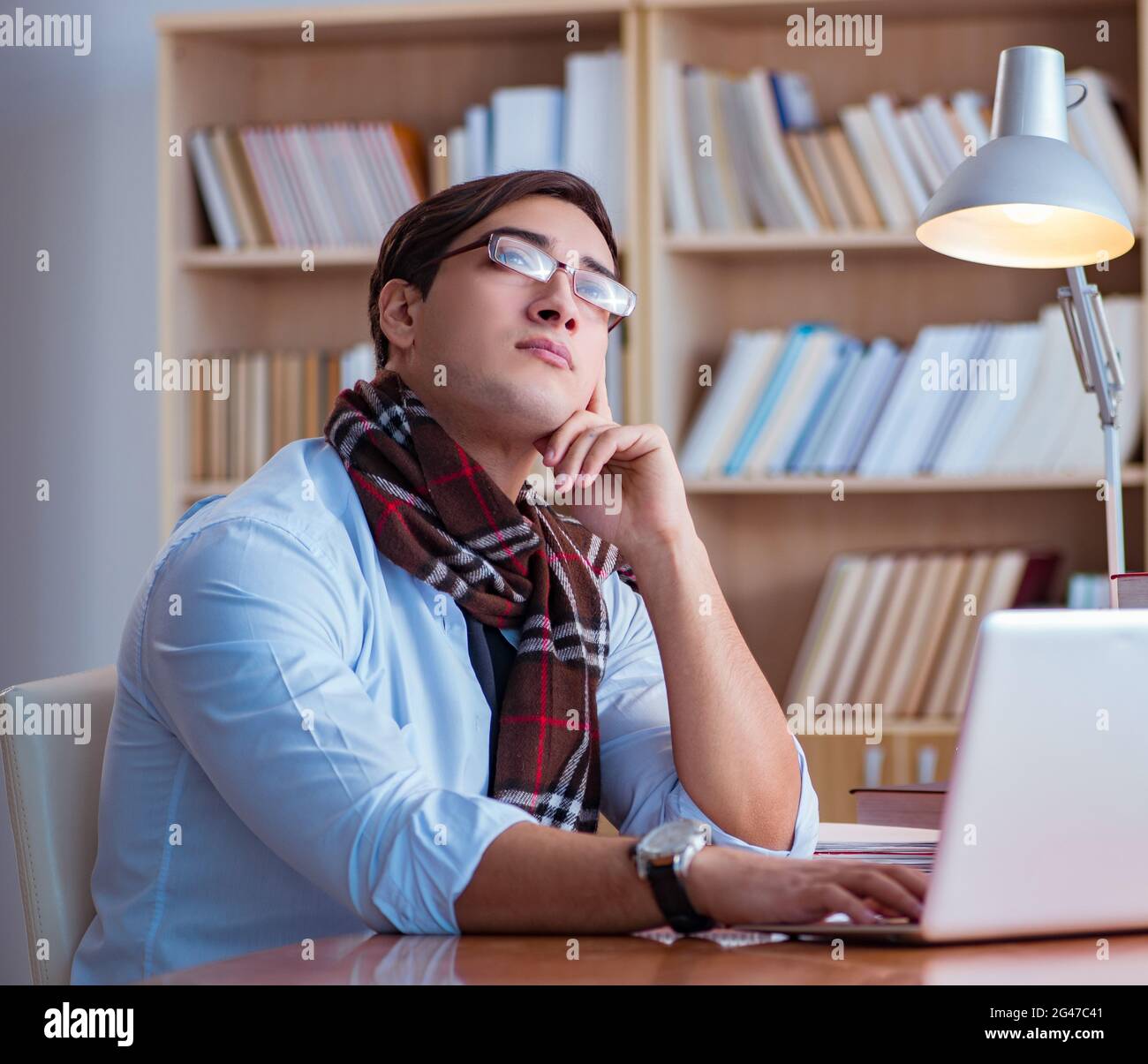 The young book writer writing in library Stock Photo - Alamy