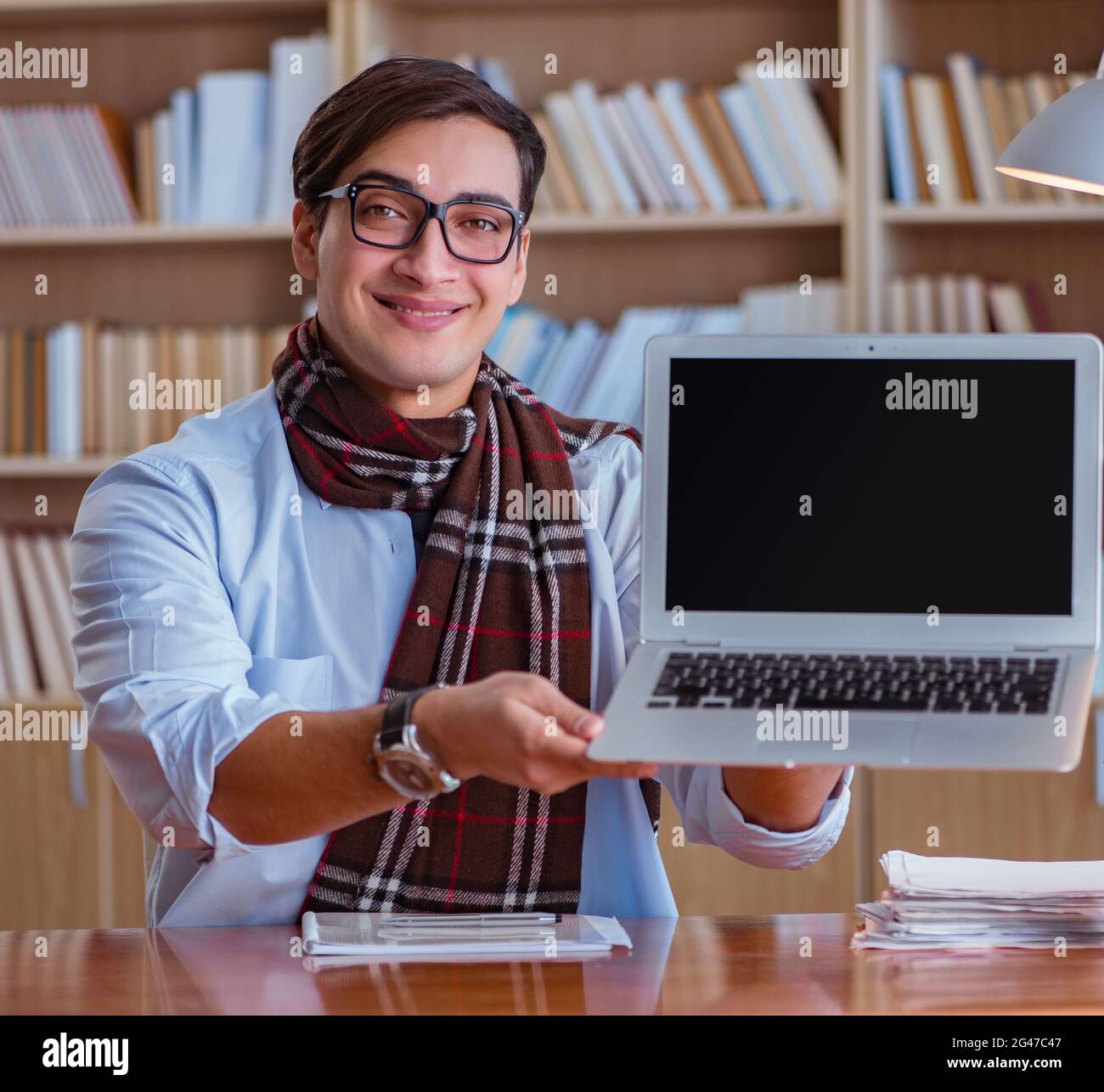 The young book writer writing in library Stock Photo - Alamy