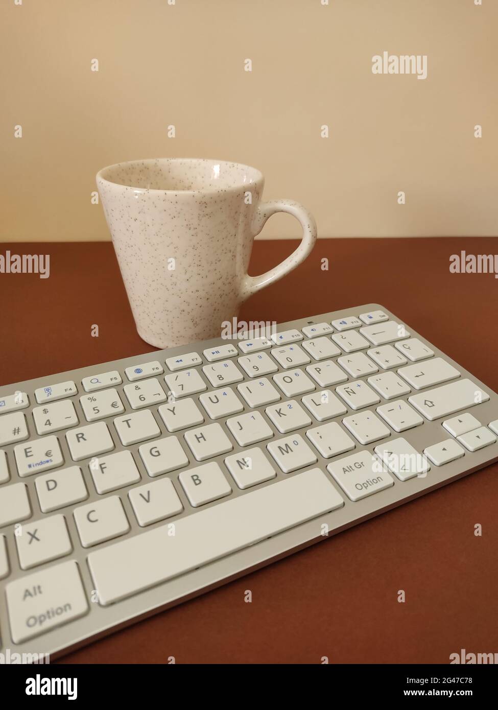 Coffee mug by the computer keyboard - working concept Stock Photo - Alamy