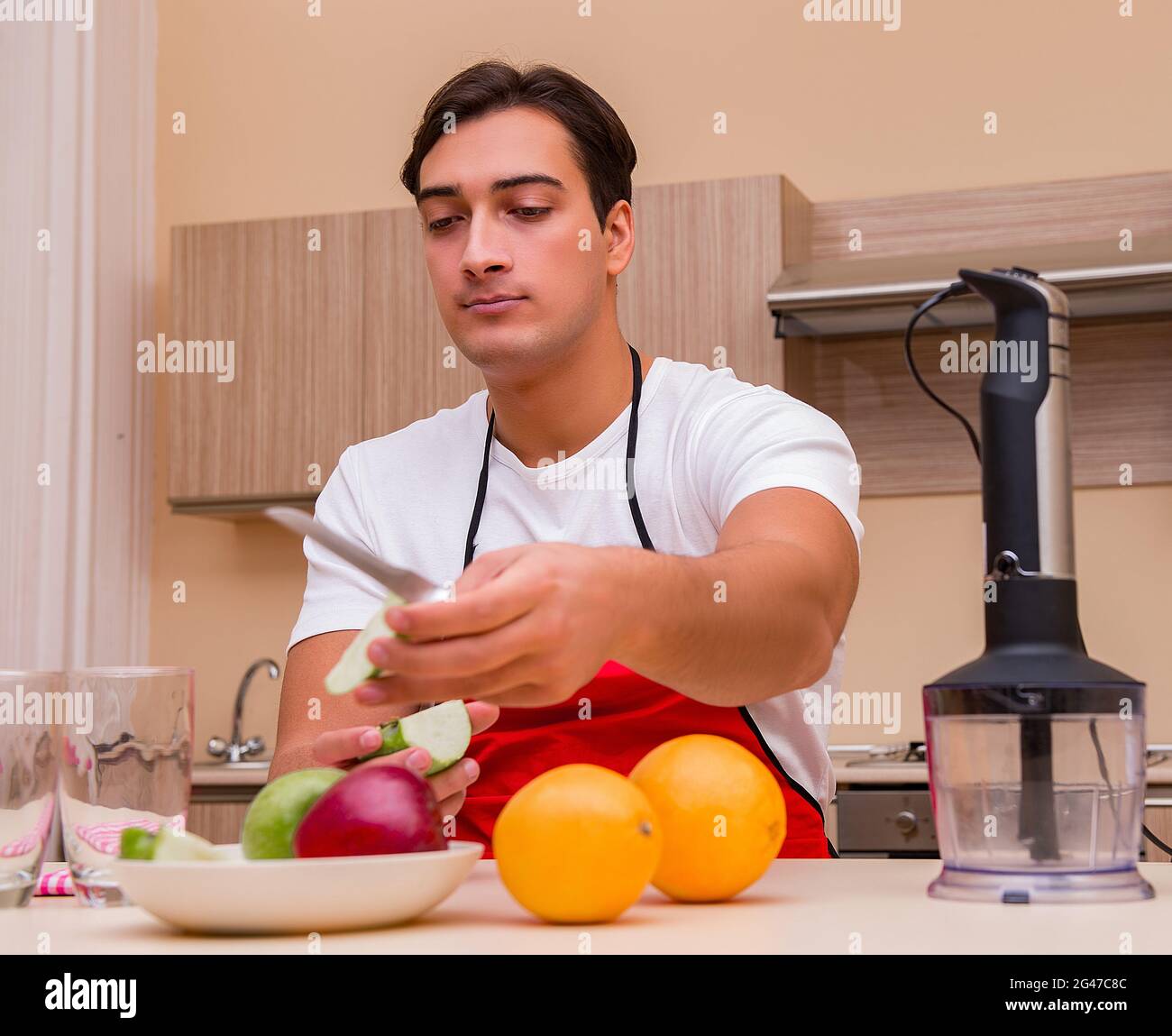 The handsome man working at the kitchen Stock Photo - Alamy