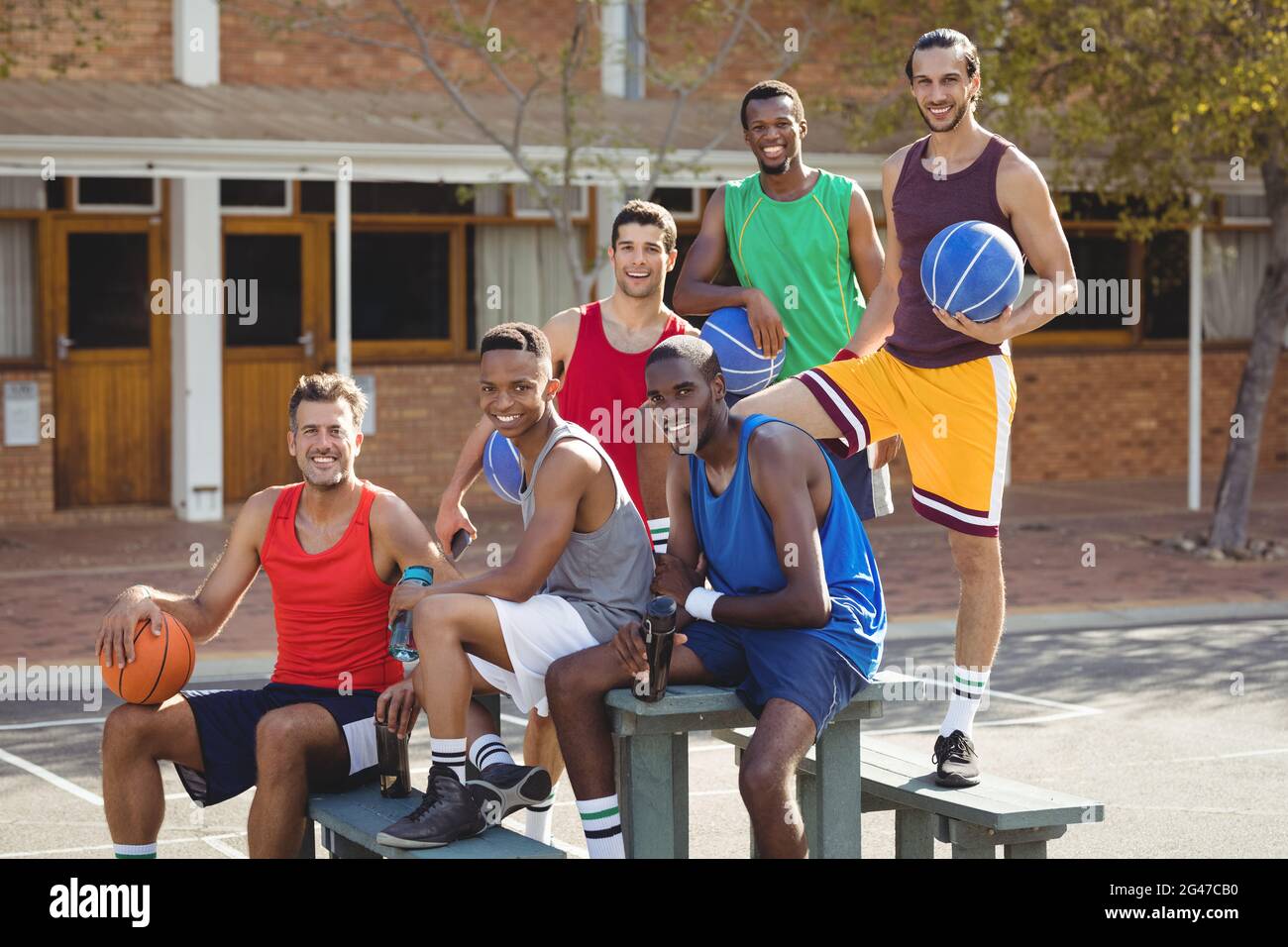 Basketball players sitting on the bench Stock Photo - Alamy
