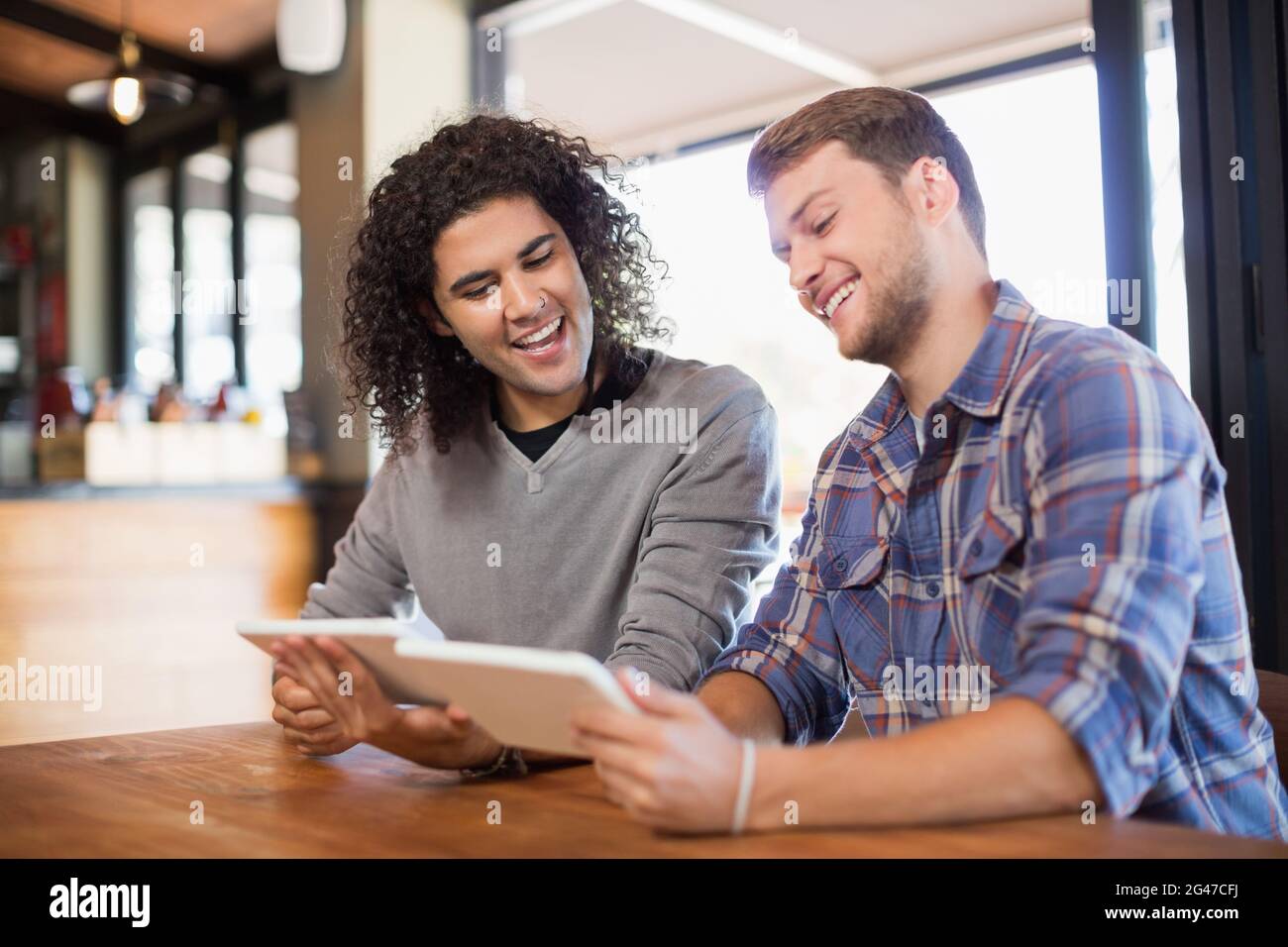Two friends using tablets hi-res stock photography and images - Alamy