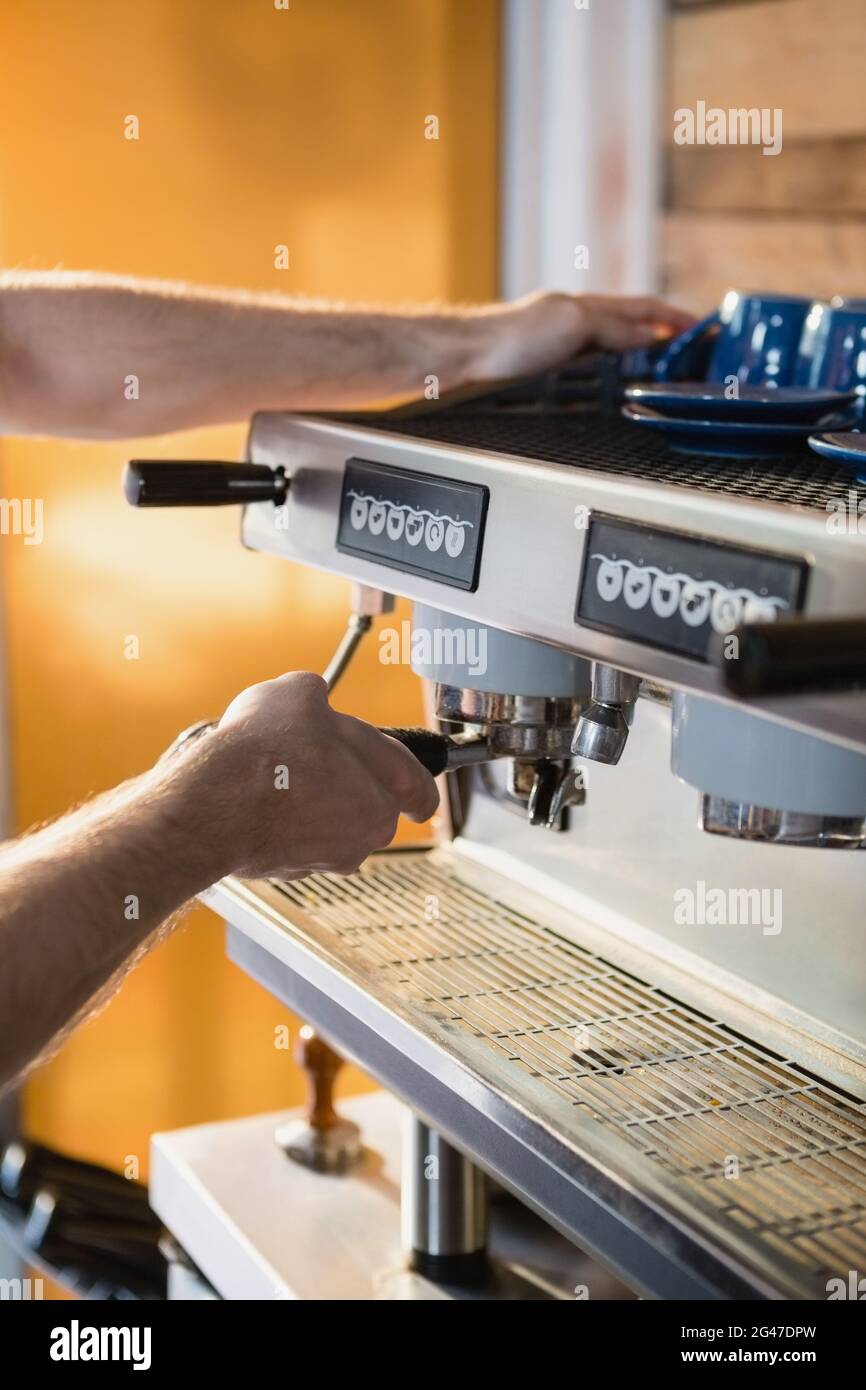 Waiter preparing coffee from coffee machine Stock Photo - Alamy