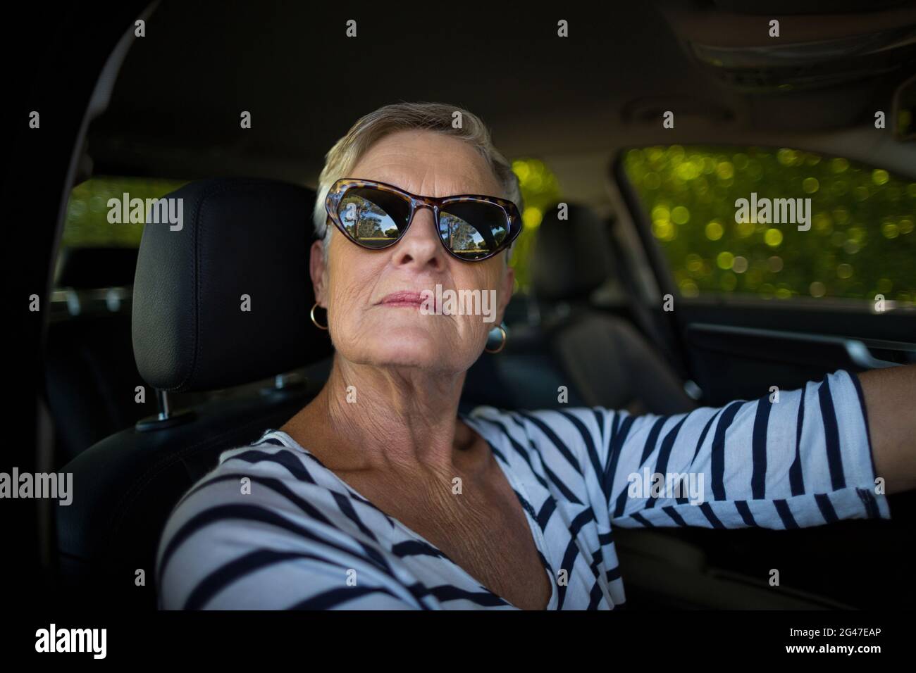 Serious senior woman driving car Stock Photo - Alamy
