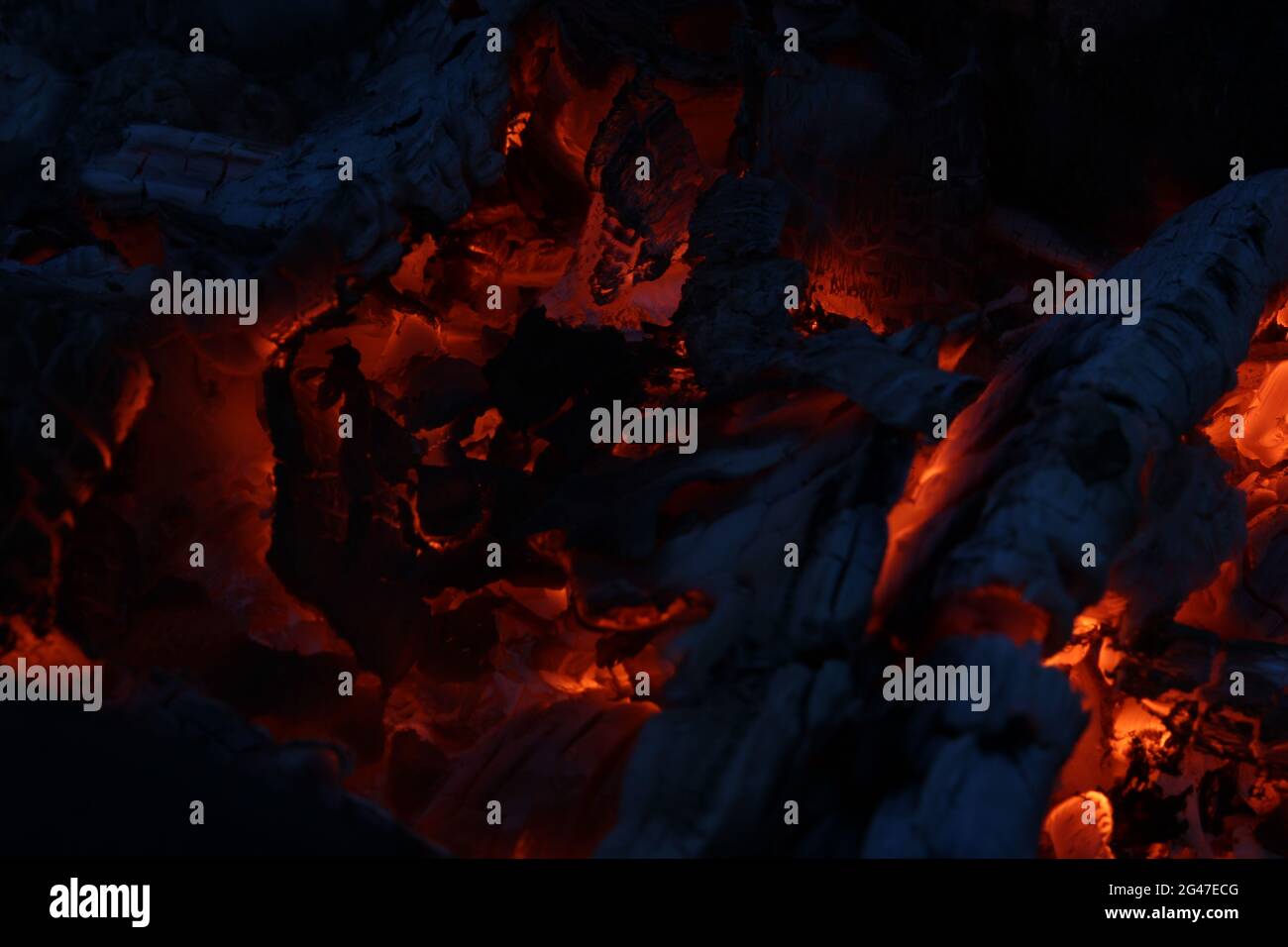 Smoldered logs burned in vivid fire close up. Atmospheric background ...