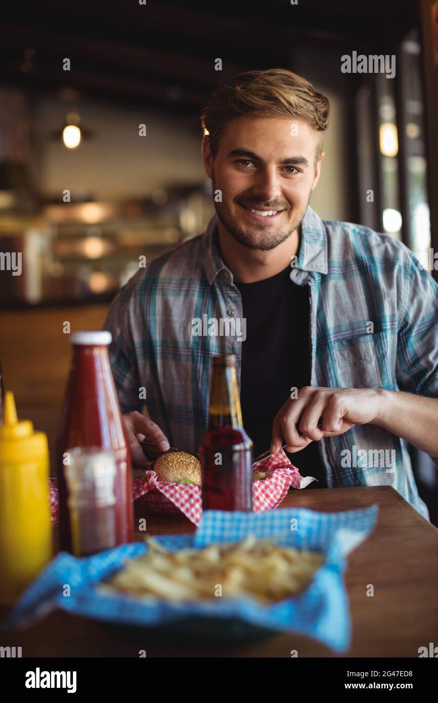 Man having burger together Stock Photo - Alamy