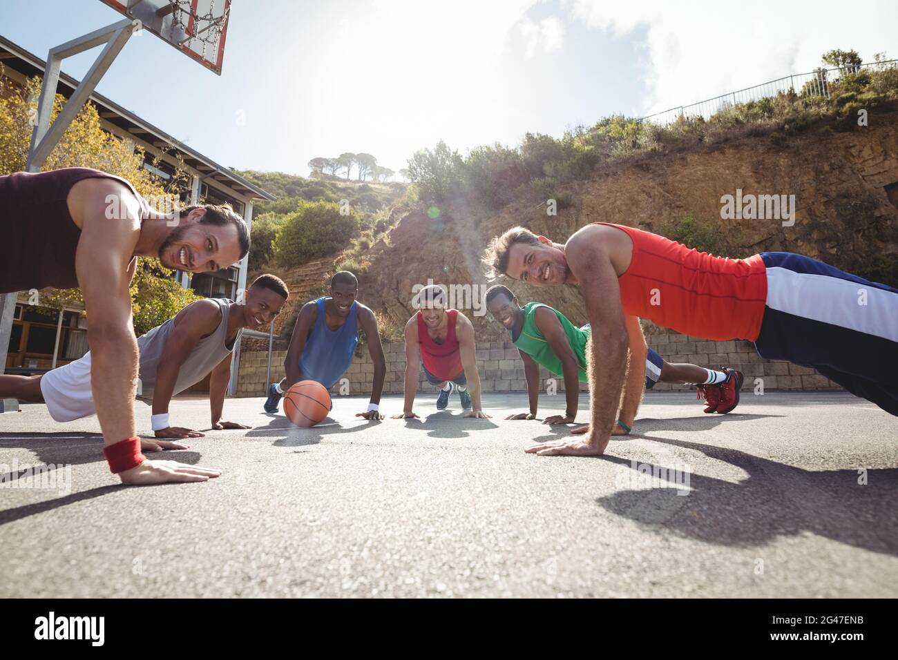 Basketball players performing push up exercise Stock Photo - Alamy