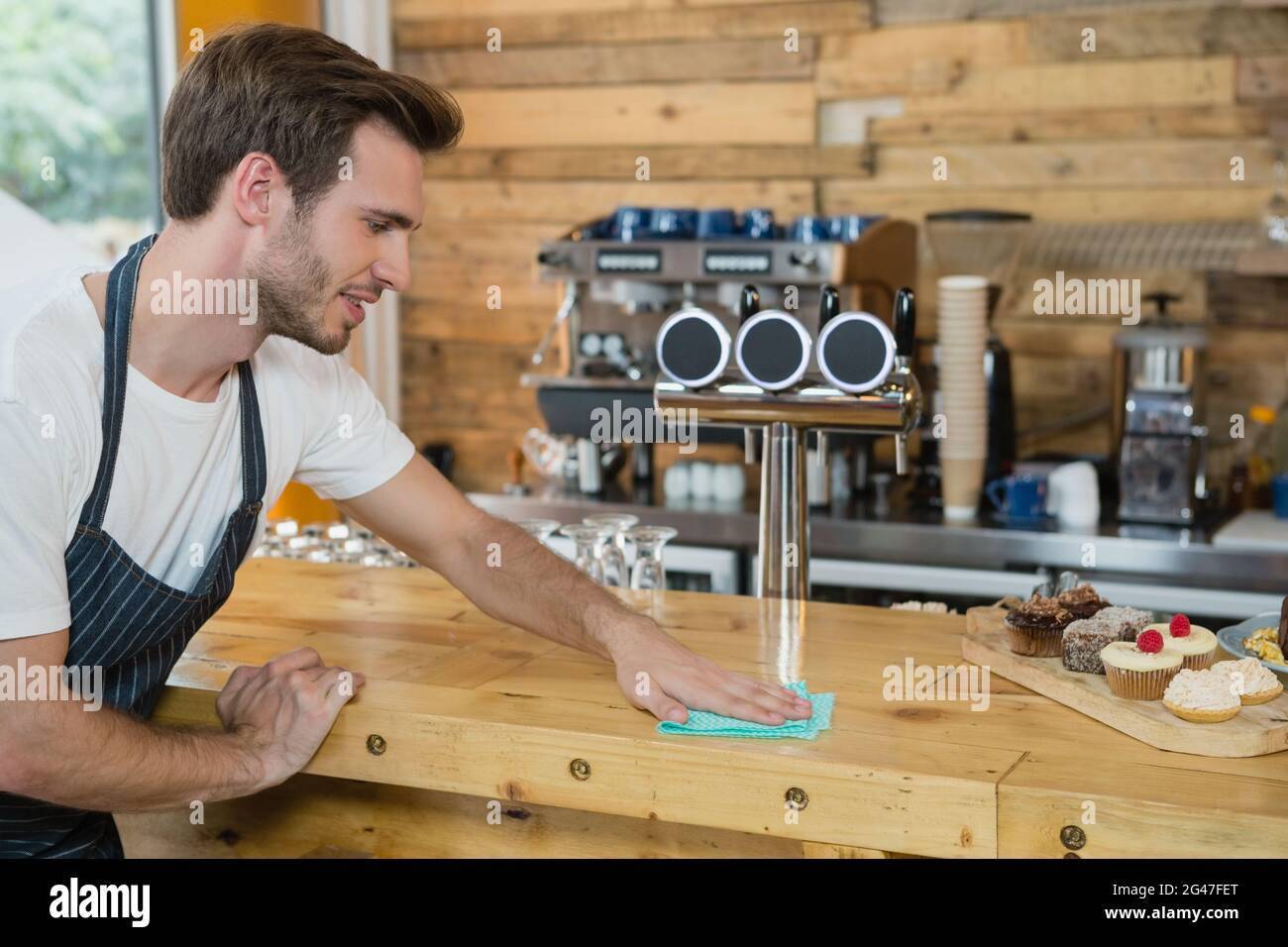 Waiter cleaning counter worktop Stock Photo - Alamy
