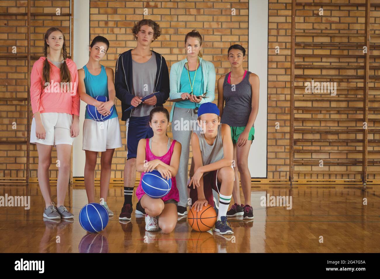 High school kids with basketball standing together in basketball court ...