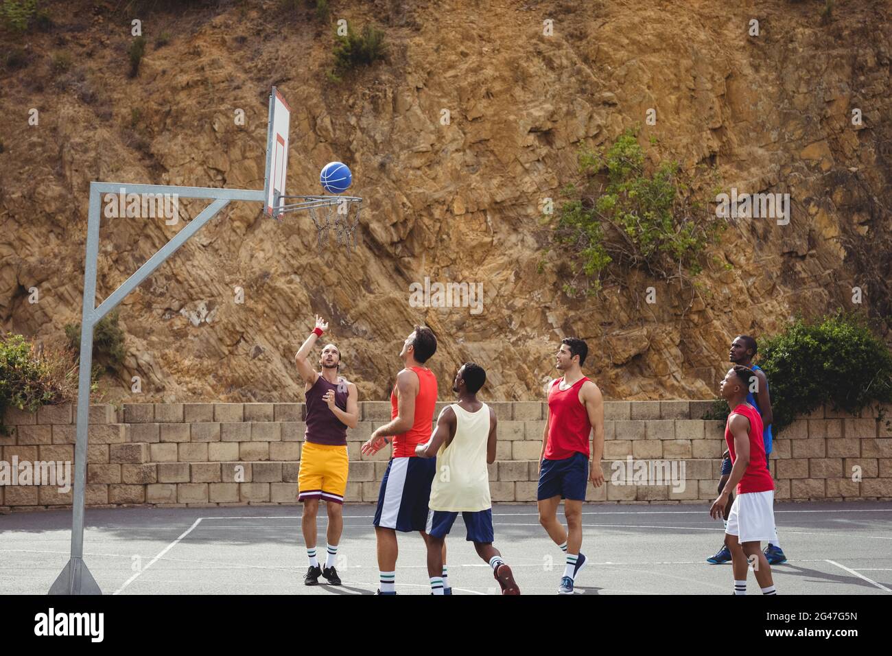 Basketball players playing basketball in the court Stock Photo - Alamy