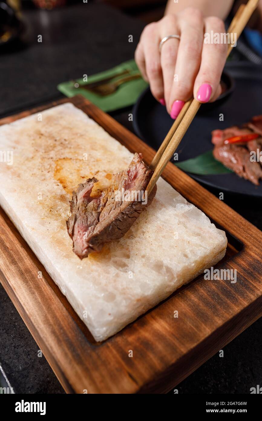 Beef tataki served on hot salt with sauce Stock Photo - Alamy