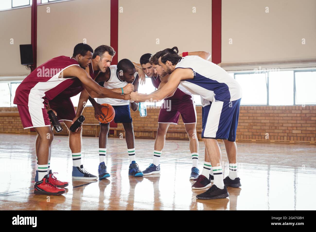 Basketball players forming a handstack in the court Stock Photo - Alamy