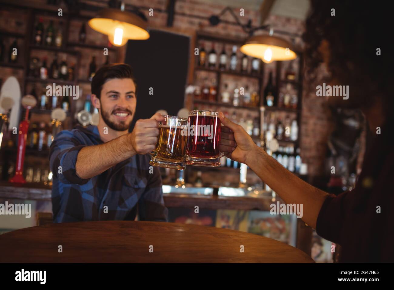 Smiling man toasting beer mug hi-res stock photography and images - Alamy