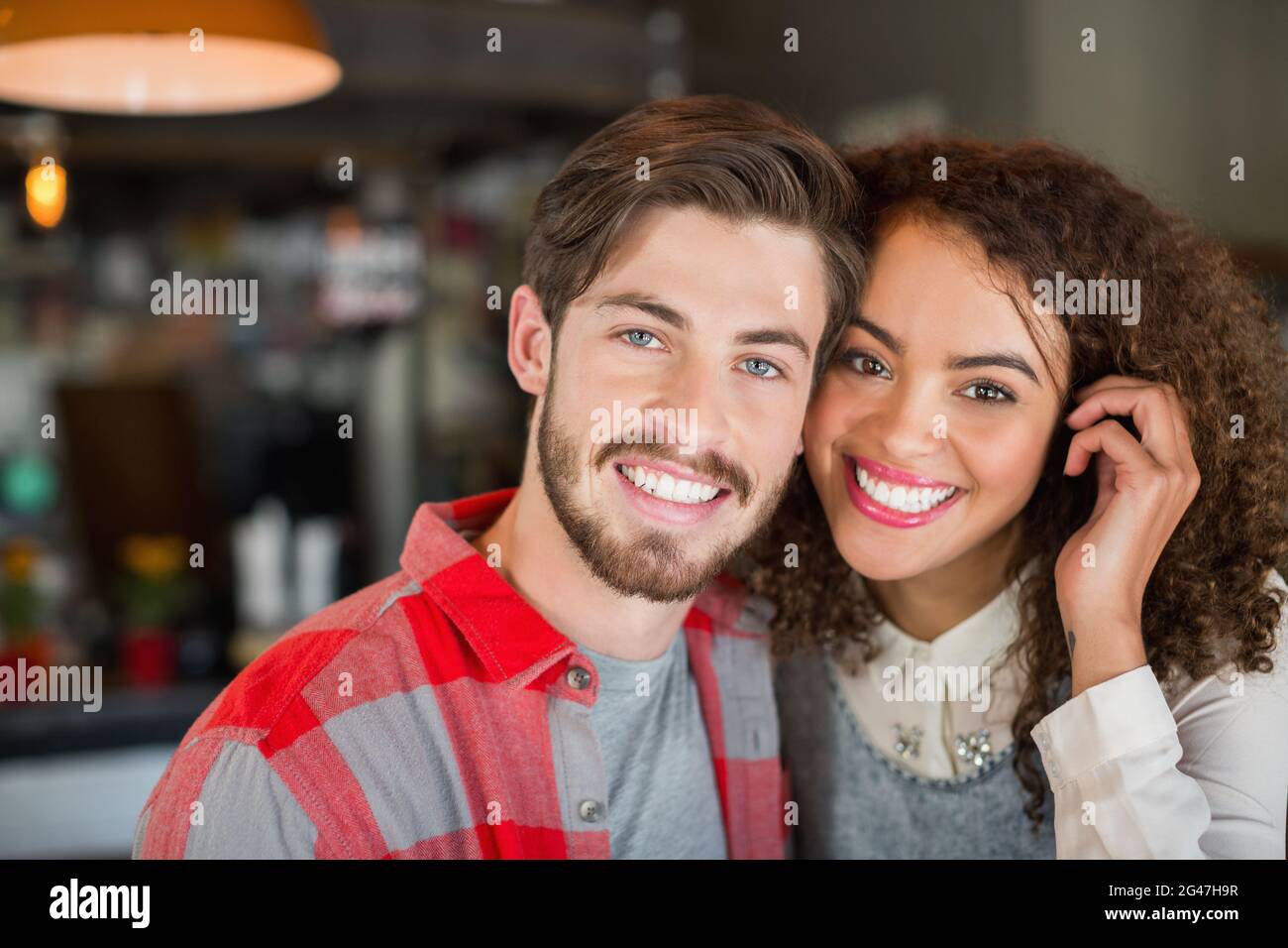 Portrait of smiling young couple Stock Photo - Alamy