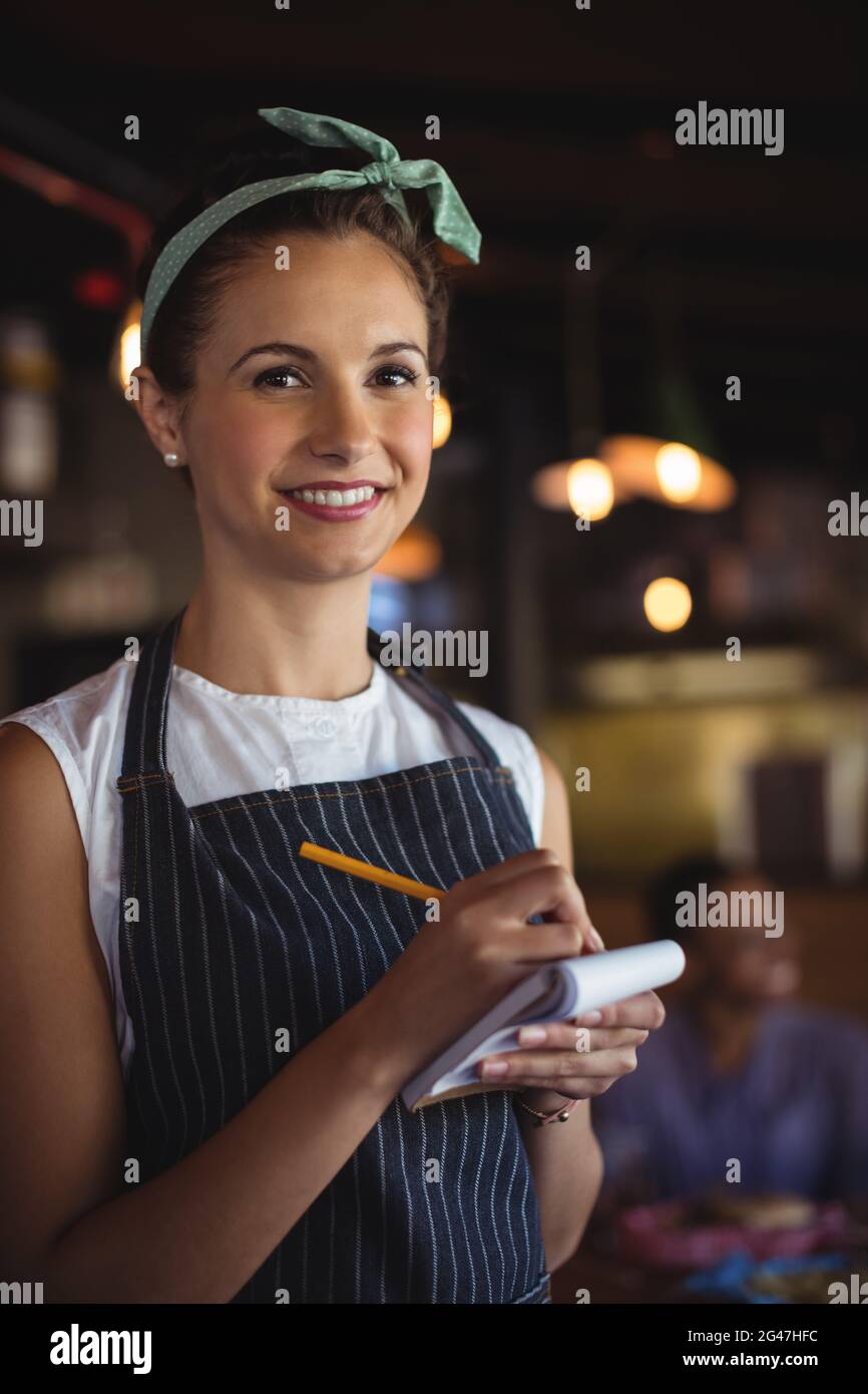 Waitress taking order at restaurant Stock Photo - Alamy