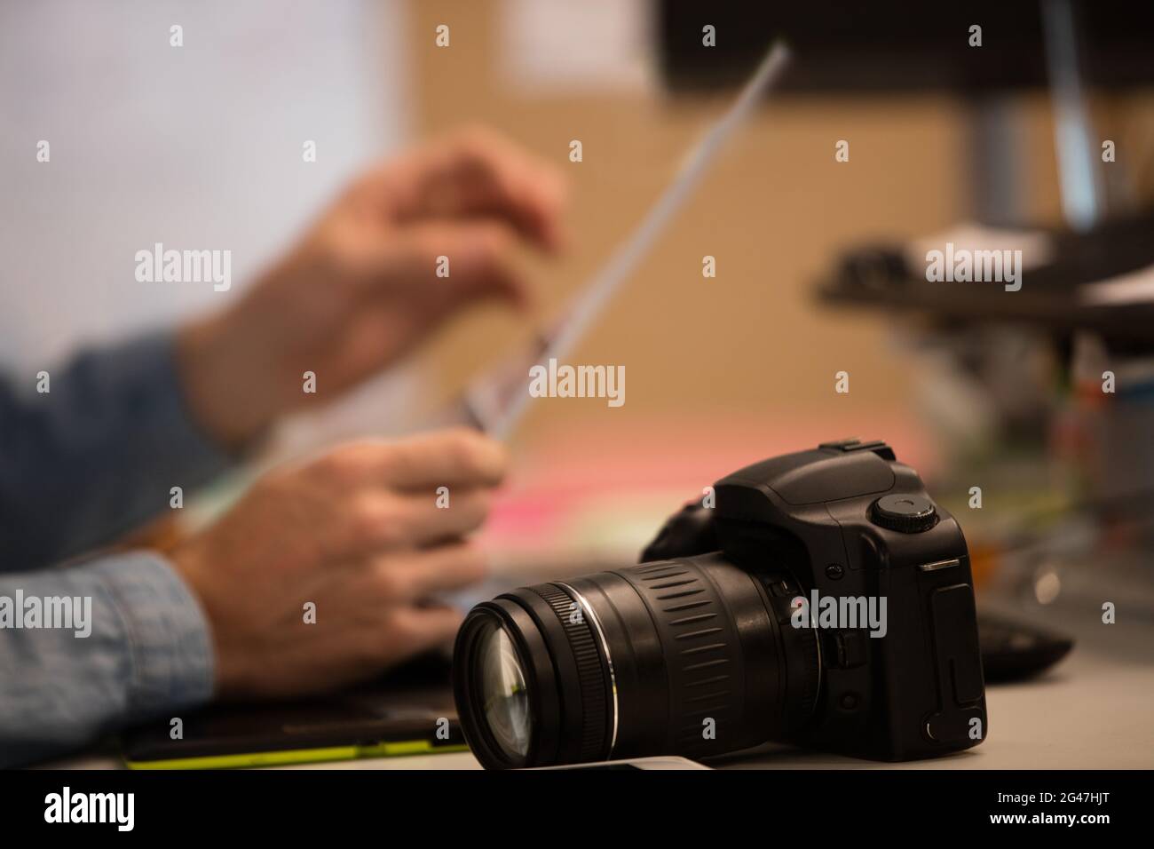 Camera on desk by photographer in creative office Stock Photo - Alamy