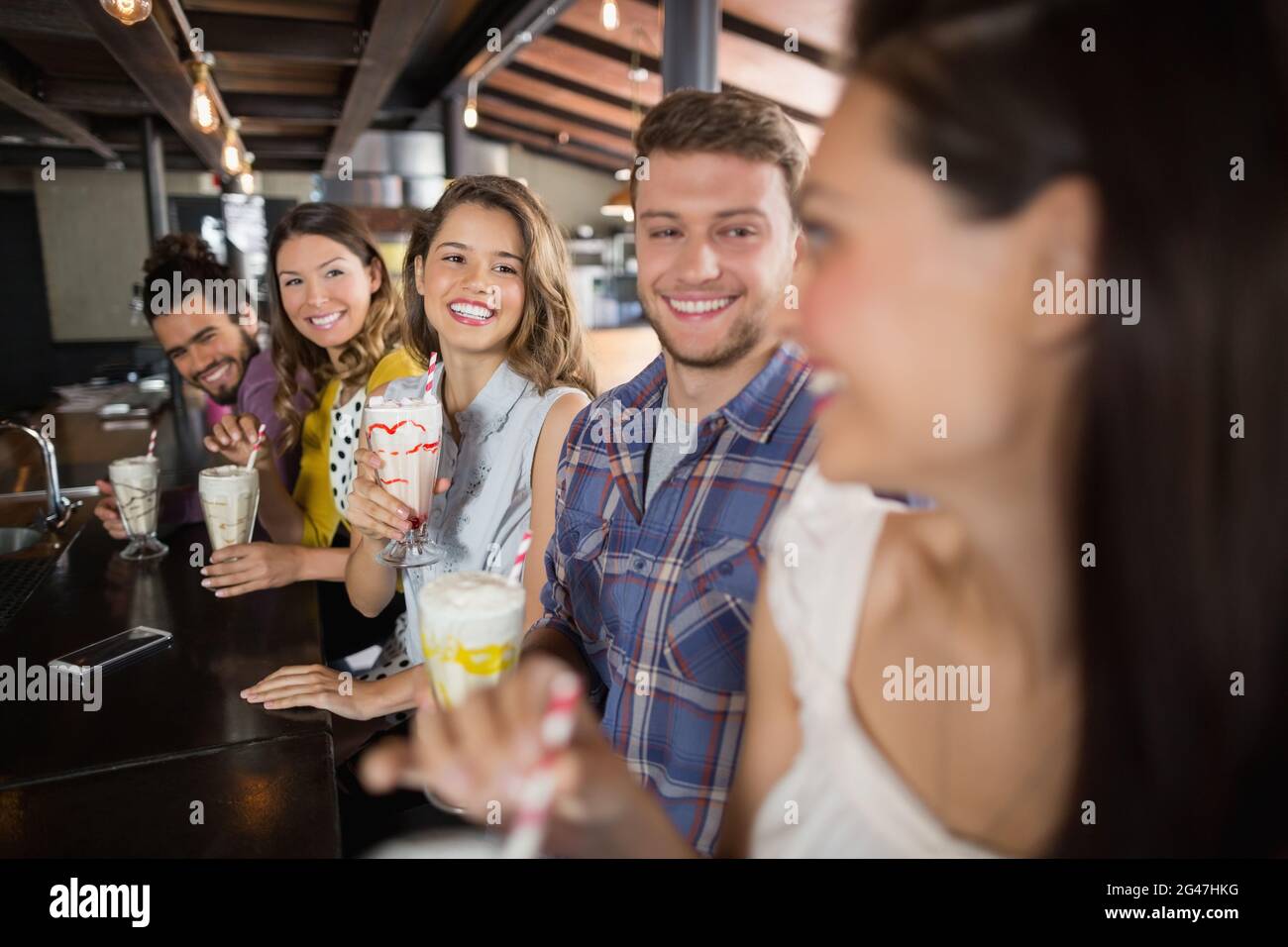 Group of friends having drinks in restaurant Stock Photo - Alamy
